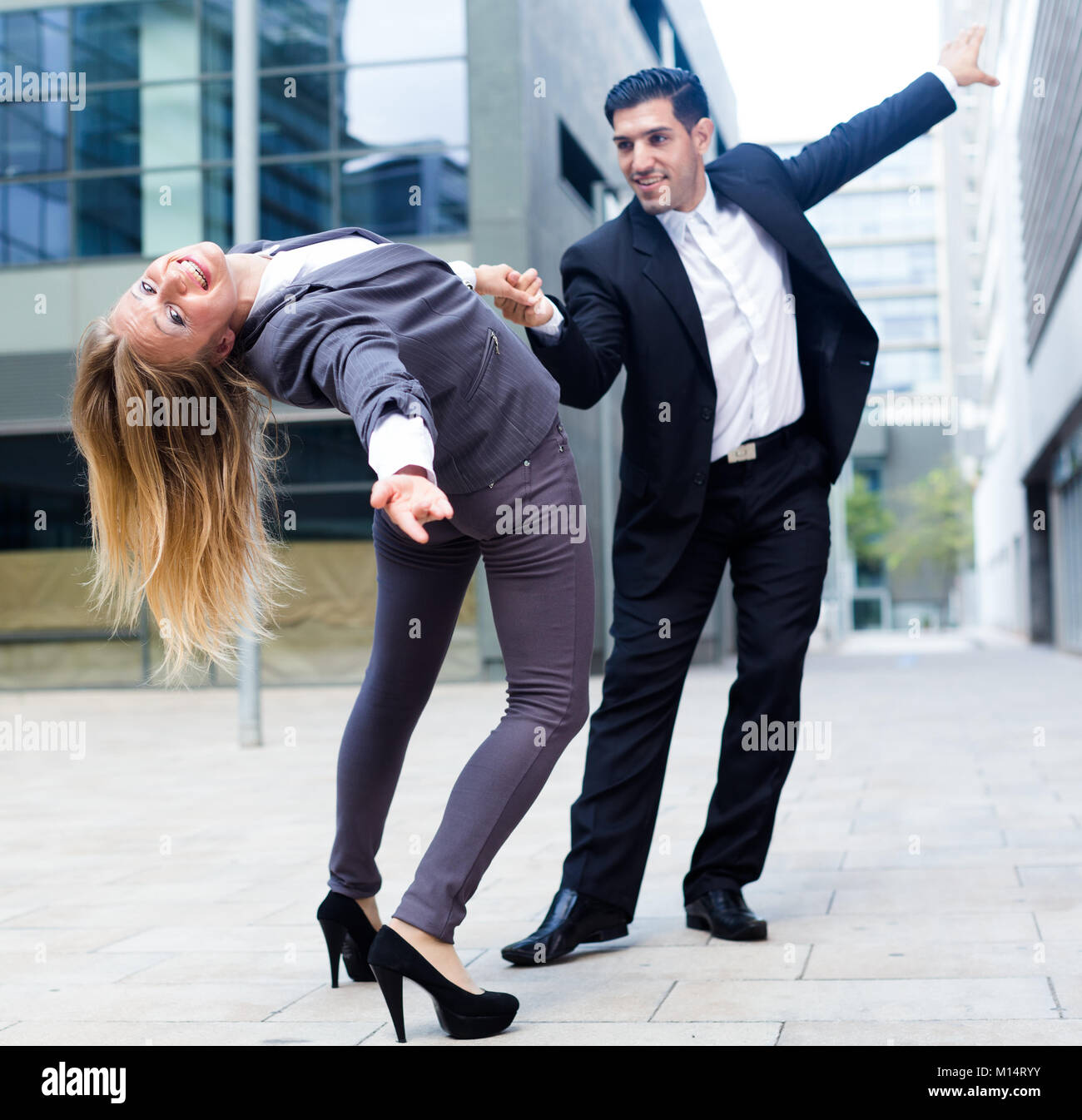 Couple of managers are dancing near office in time break Stock Photo ...