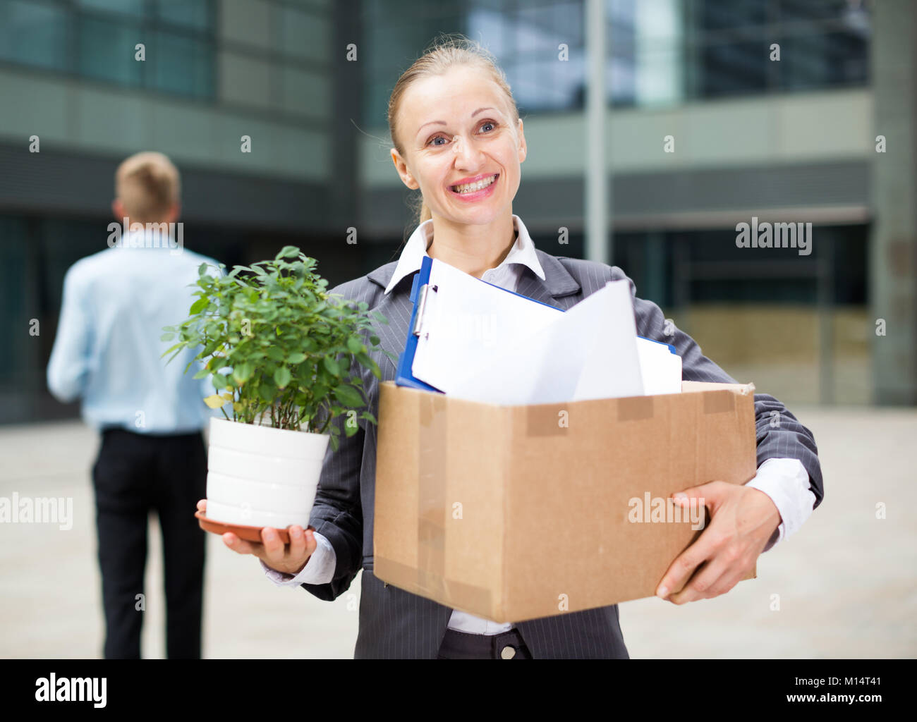 Businesswoman is standing happy near office because she leave bad job ...