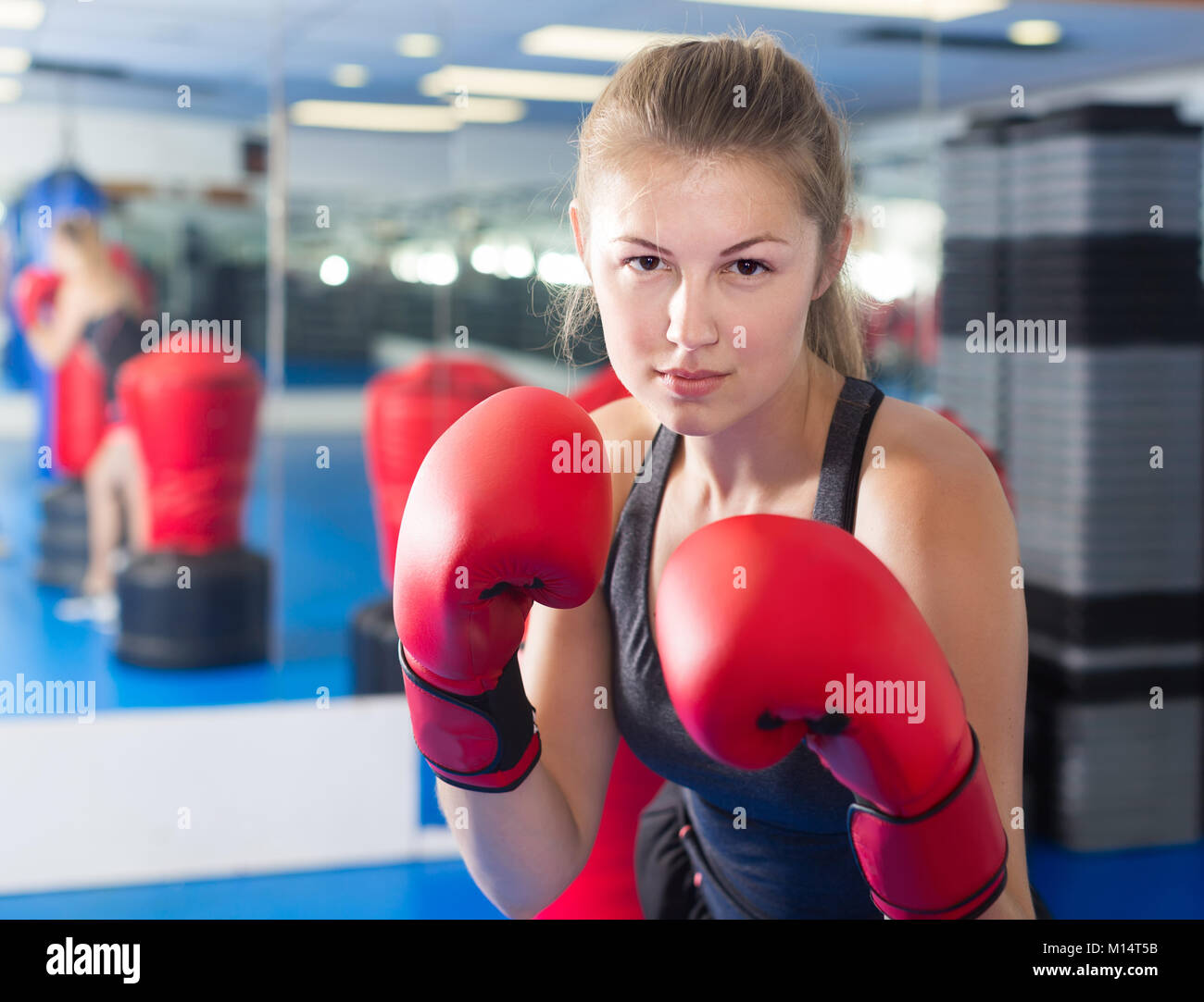 Portrait of positive greek woman who is training in box gym Stock Photo ...