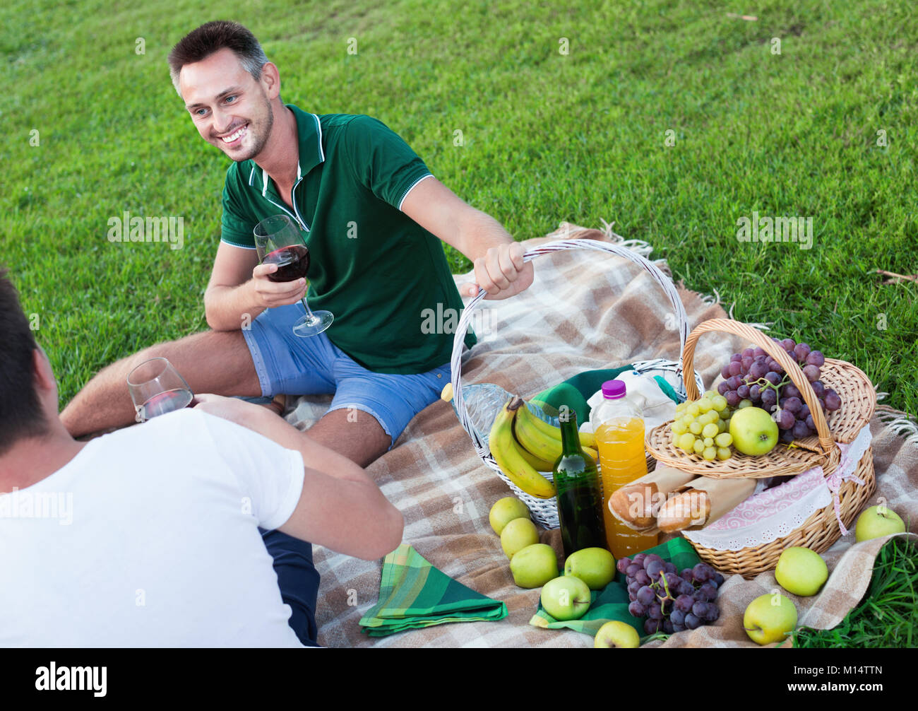 Happy cheerful smiling man enjoying life on picnic outdoors with his ...