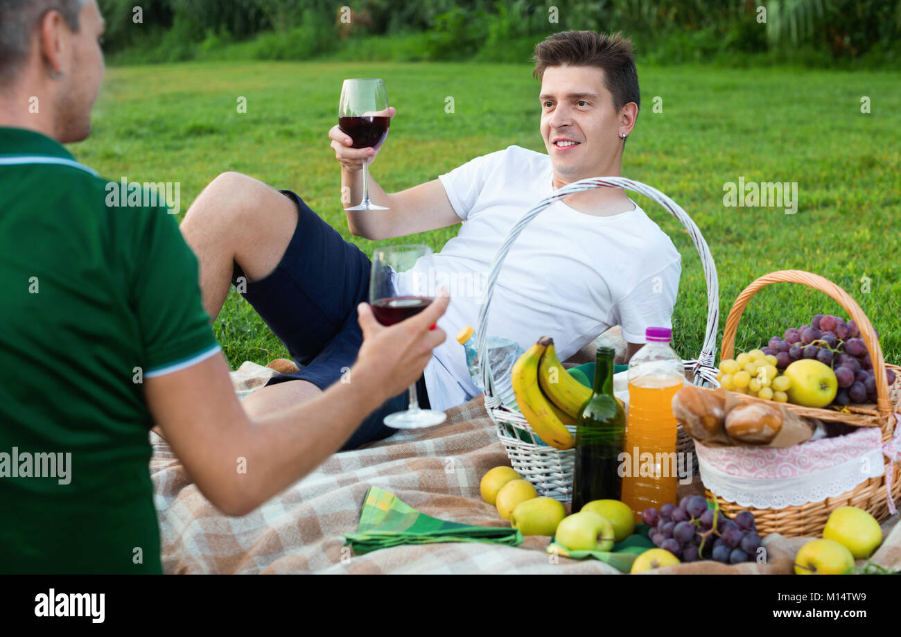 Cheerful man enjoying life on picnic outdoors with his friend Stock ...