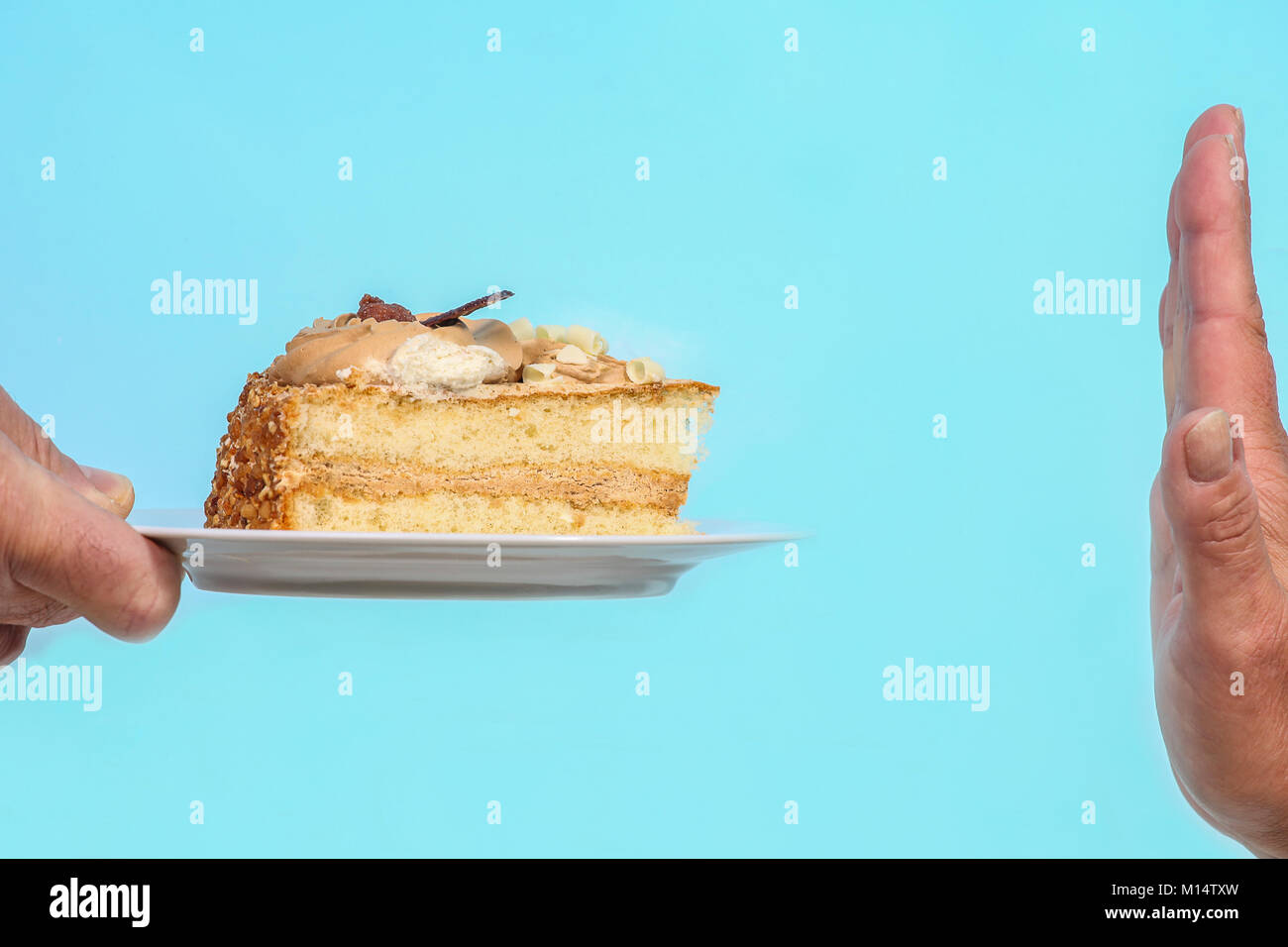 Hand gesturing no to a slice of cake Stock Photo - Alamy