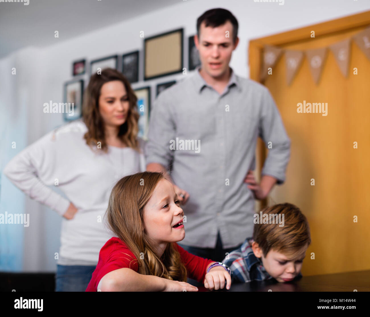 Young parents lecturing their children for bad behavior at home Stock ...