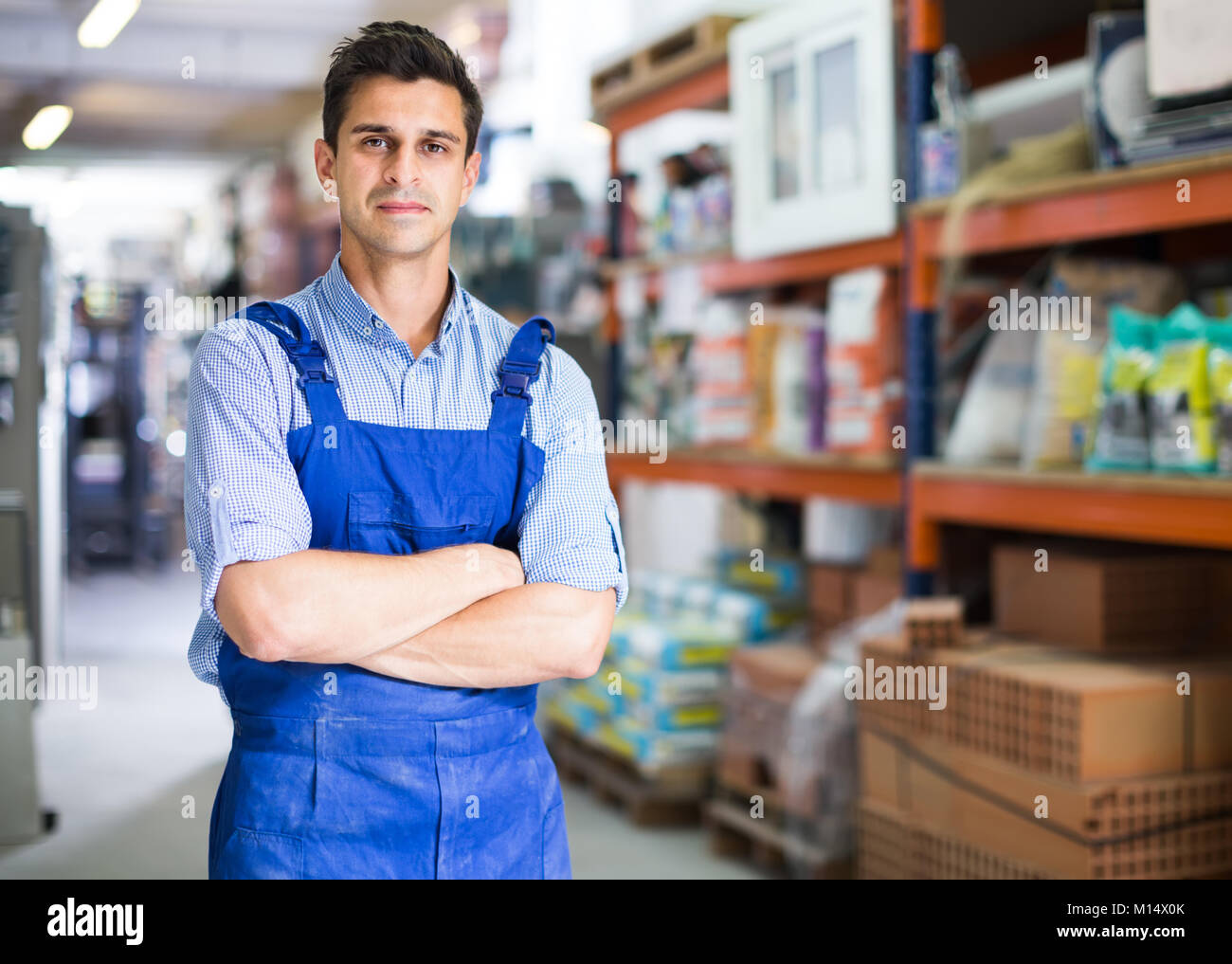 Portrait of attractive working man in uniform on his workplace in ...