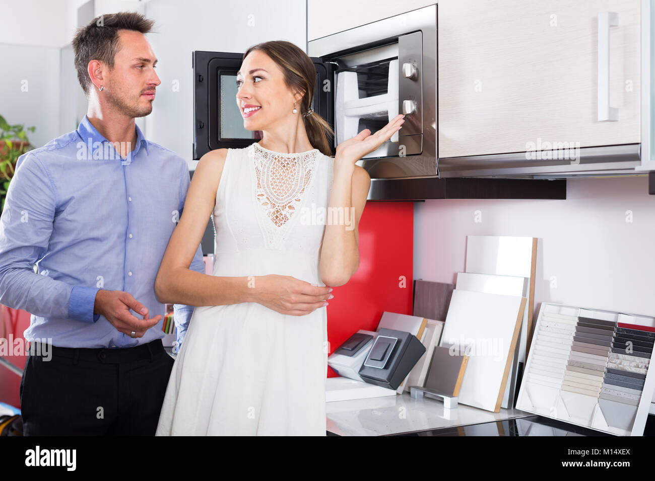 middle class married couple selecting modern kitchen furniture Stock ...