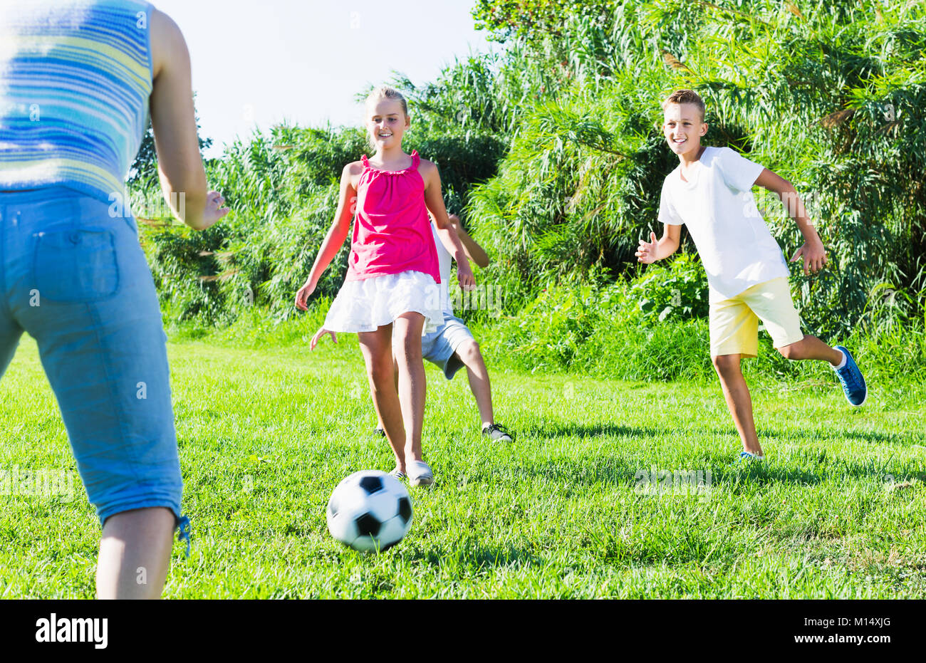 Group of laughing children having fun together outdoors playing ...