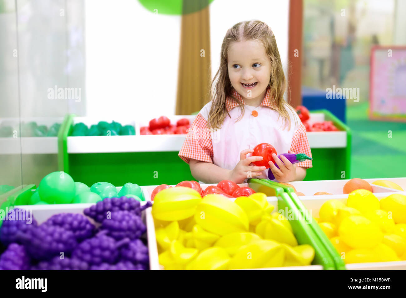 Child playing in toy shop or restaurant. Educational toys and role game ...