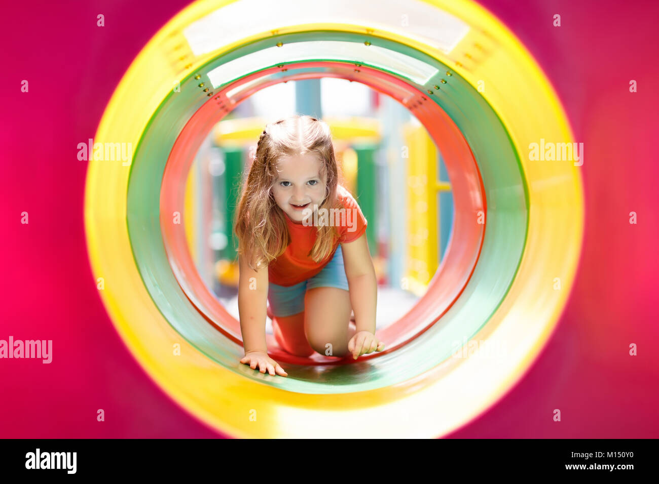 Kids climbing and sliding on outdoor playground. Children play in sunny ...