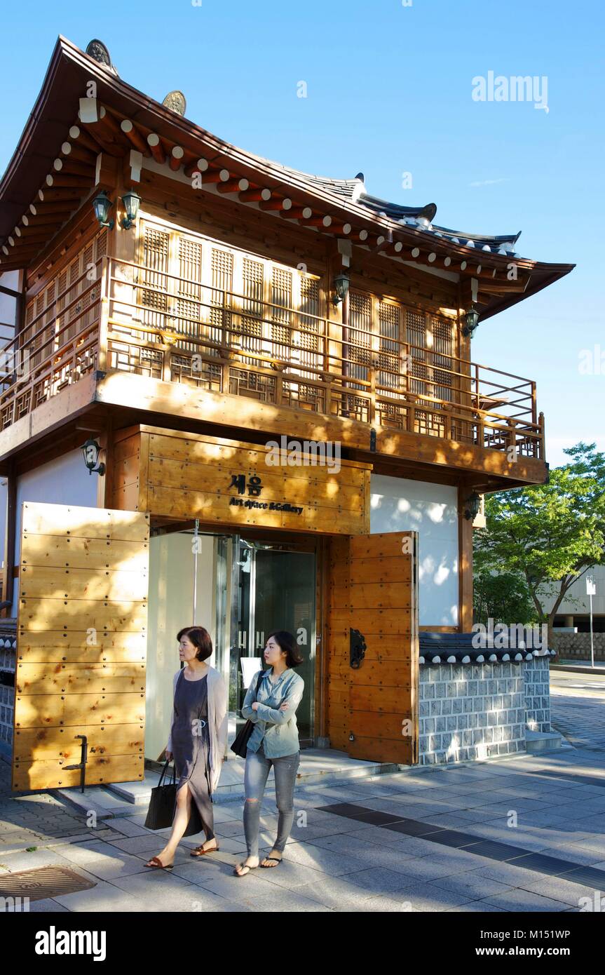 South Korea, Seoul, women passing in front of a art gallery installed ...
