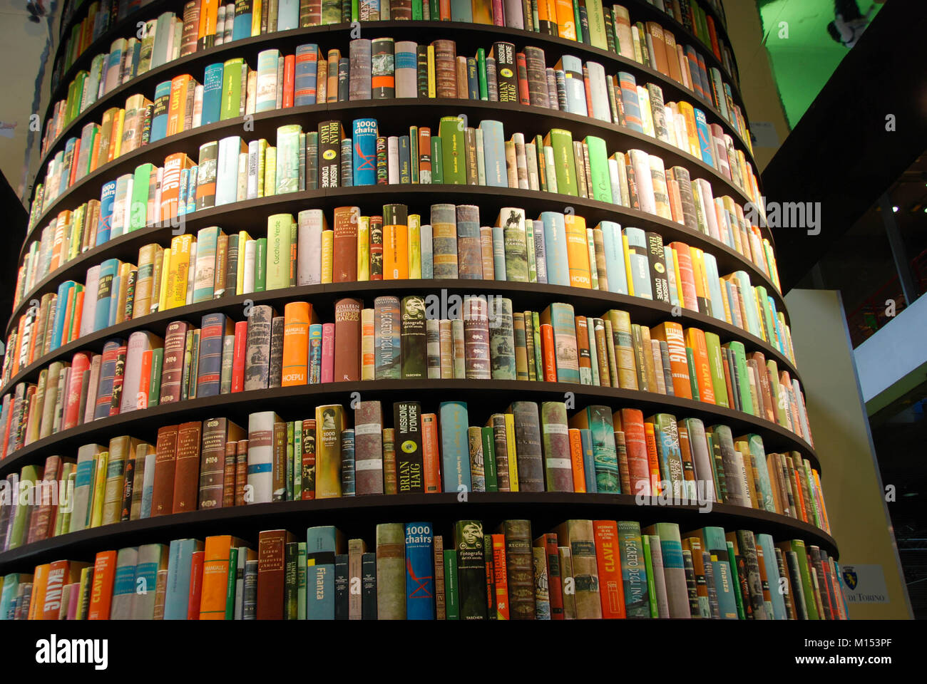 Books in a tower-shaped bookcase Stock Photo - Alamy