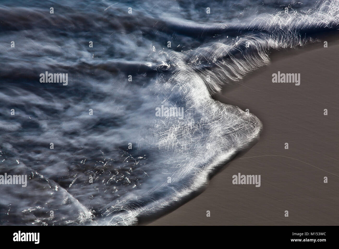 Very close view of calm Atlantic Ocean wave as it arrives at the ...