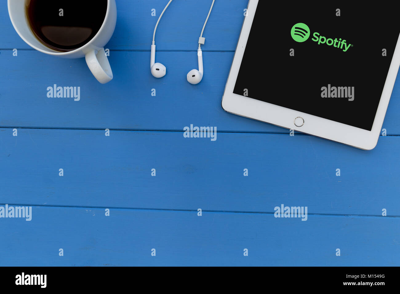 LONDON - JANUARY 25, 2018: Music earphones and Spotify music streaming ...