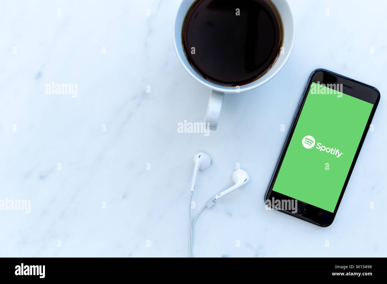 LONDON - JANUARY 25, 2018: Spotify music streaming app with green logo ...
