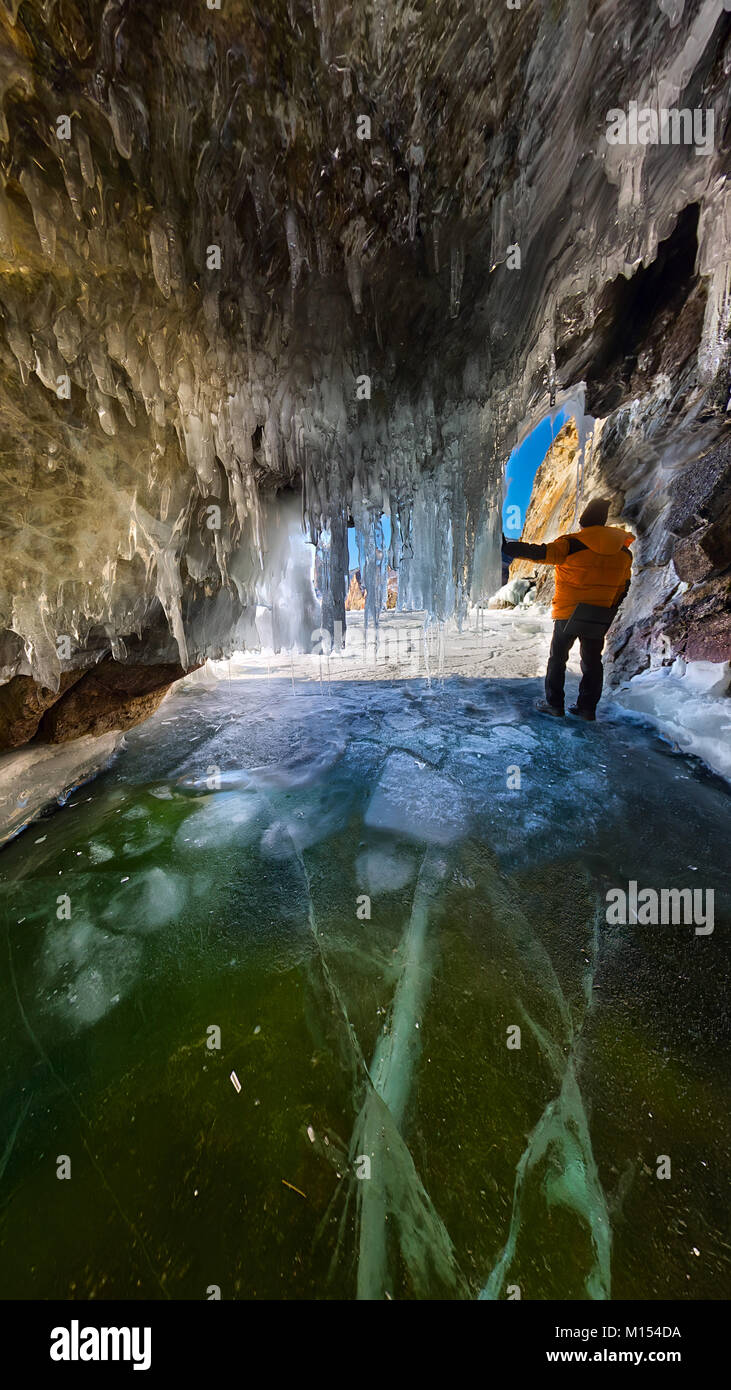 Panorama man in an ice cave with icicles on Baikal, Olkhon Stock Photo ...