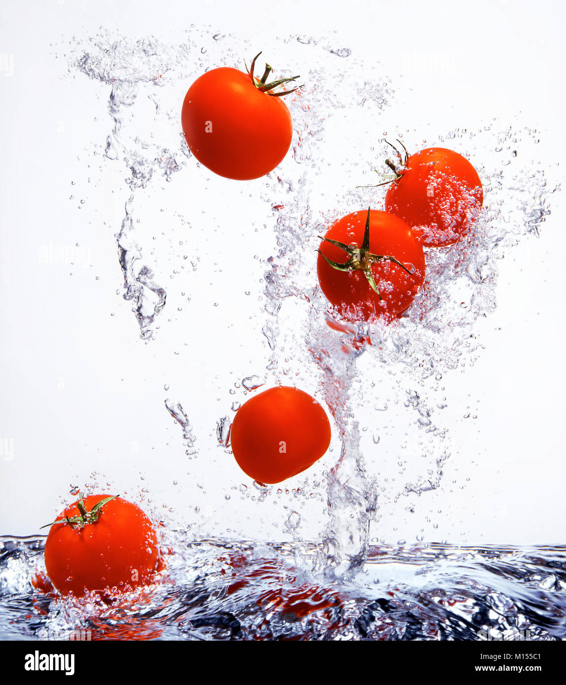 tomatoes splash with water Stock Photo - Alamy