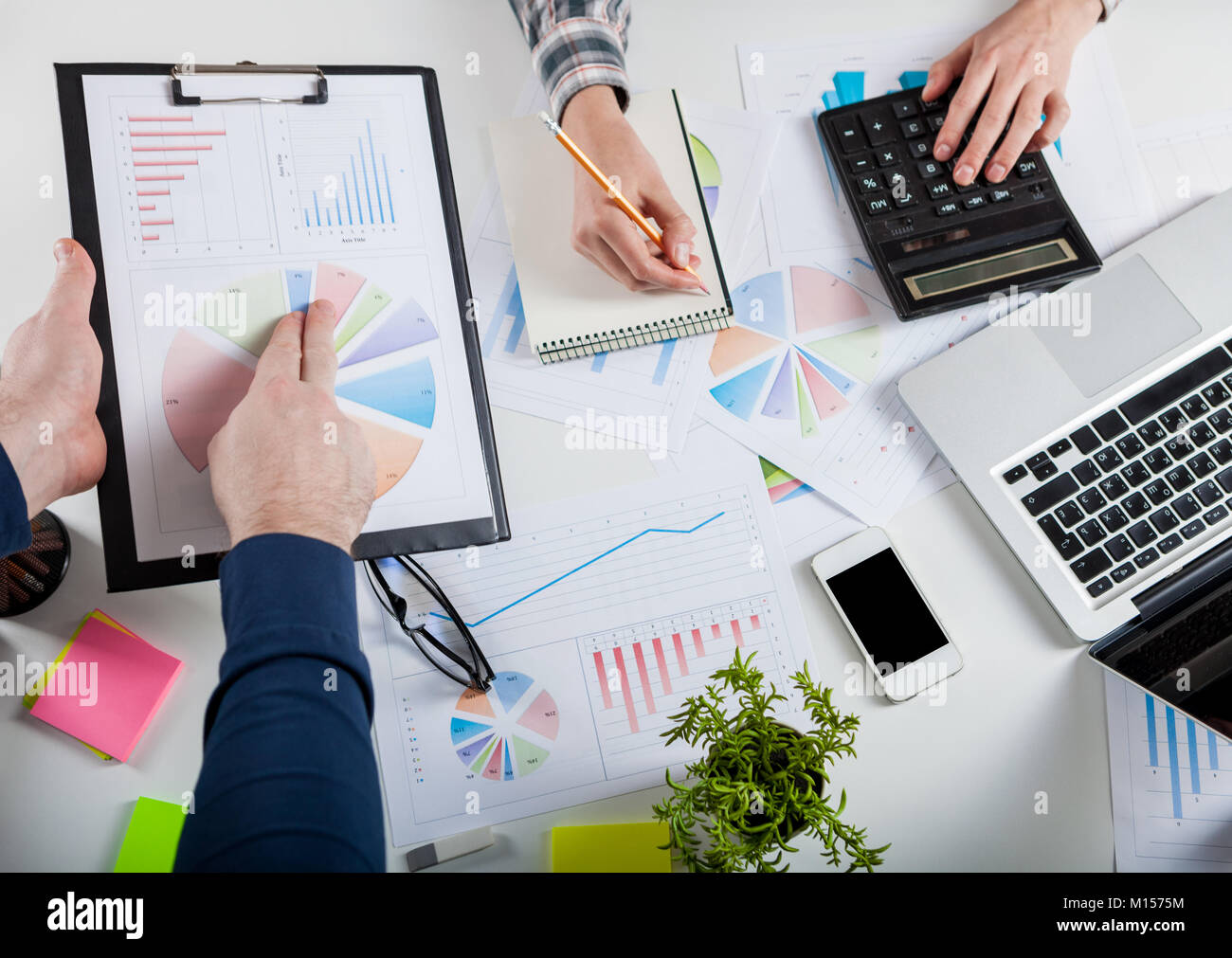 Business people discussing the charts and graphs showing the results of ...