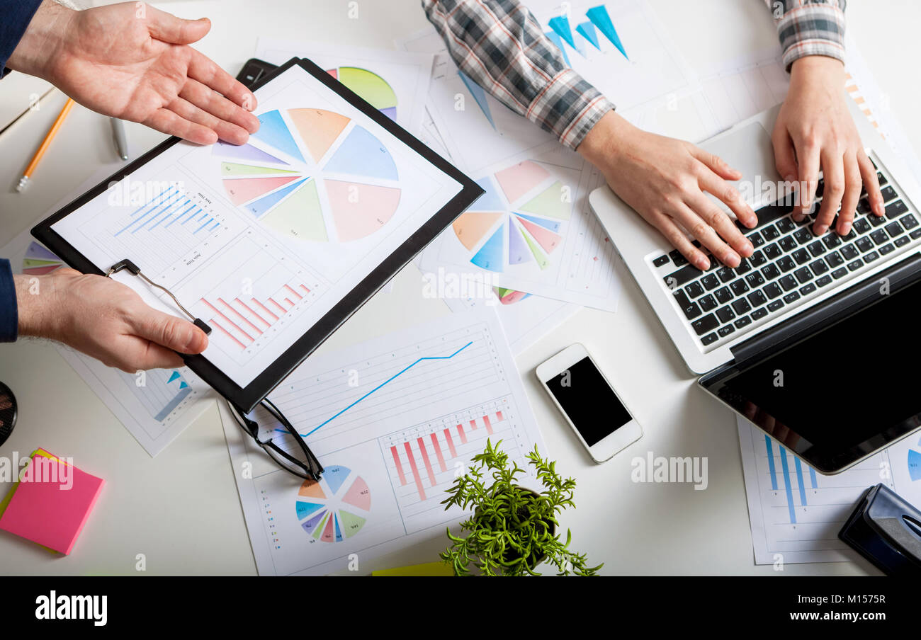 Business people discussing the charts and graphs showing the results of ...