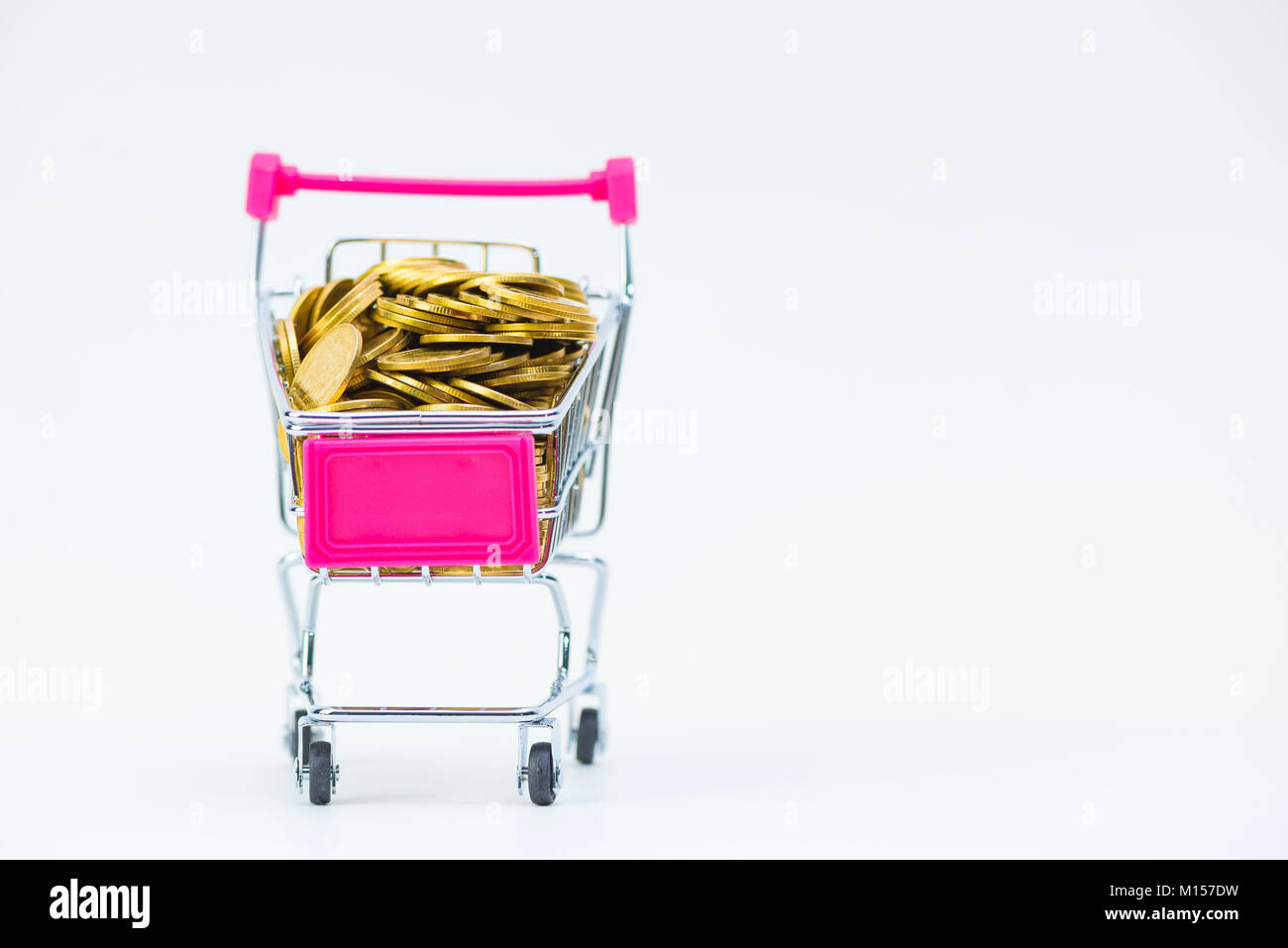 Stack of coins in shopping cart or supermarket trolley on white ...