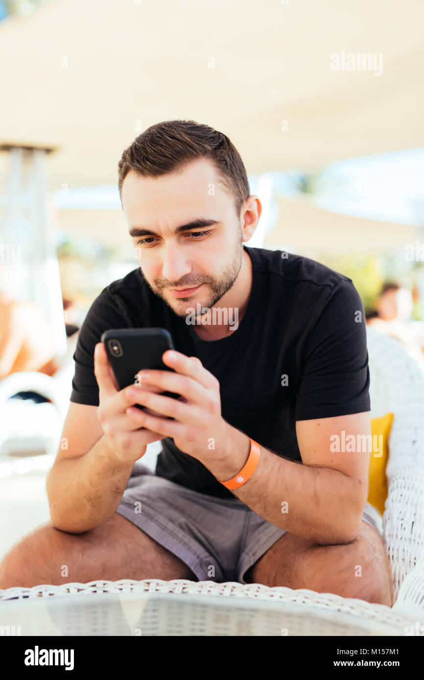 Young man calling by cell phone in outdoor cafe Stock Photo - Alamy