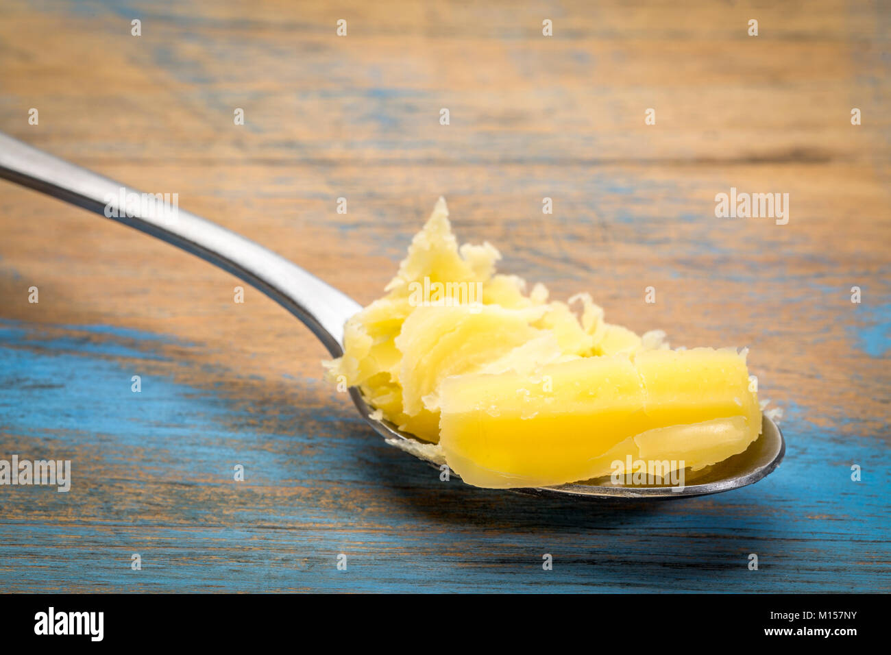 tablespoon of ghee (clarified butter) on grunge wood Stock Photo - Alamy
