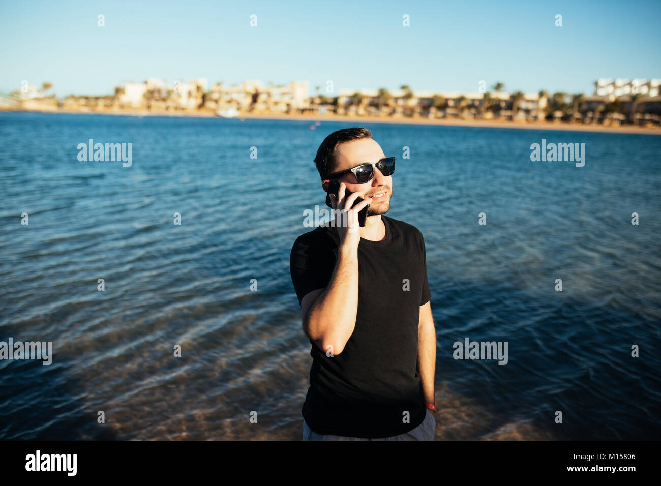 Happy young guy taking selfie with mobile phone while on vacation at ...