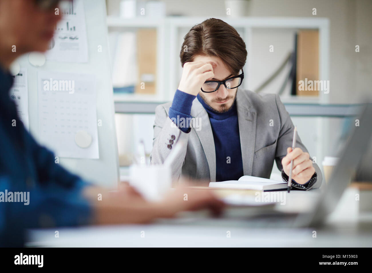Young businessman thinking writing notes hi-res stock photography and ...