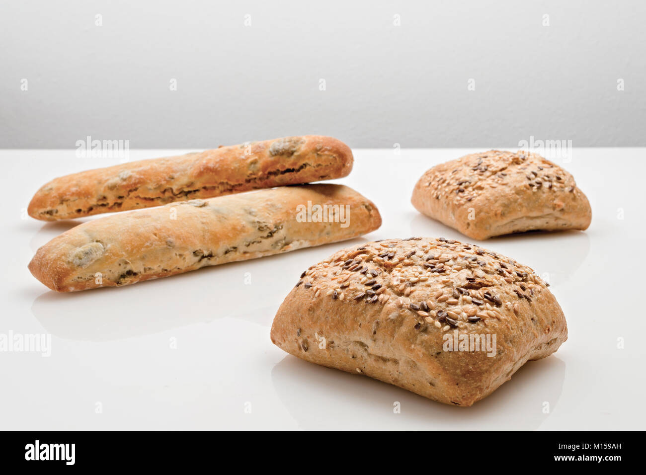 Italian special bread with olives and various seeds on white background ...