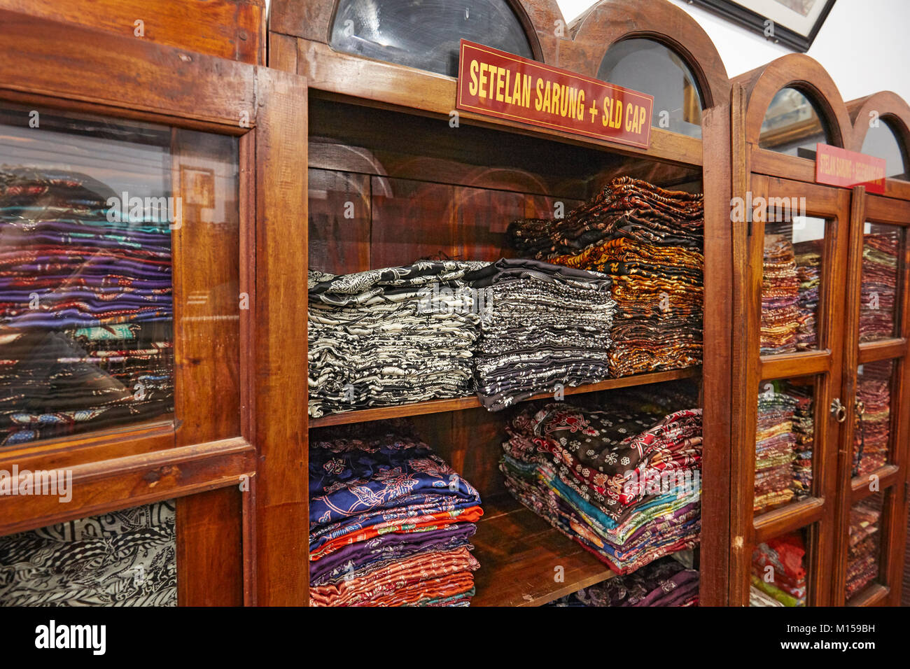 Stacks of folded silk batik sarongs for sale in Hamzah Batik shop. Yogyakarta, Java, Indonesia ...