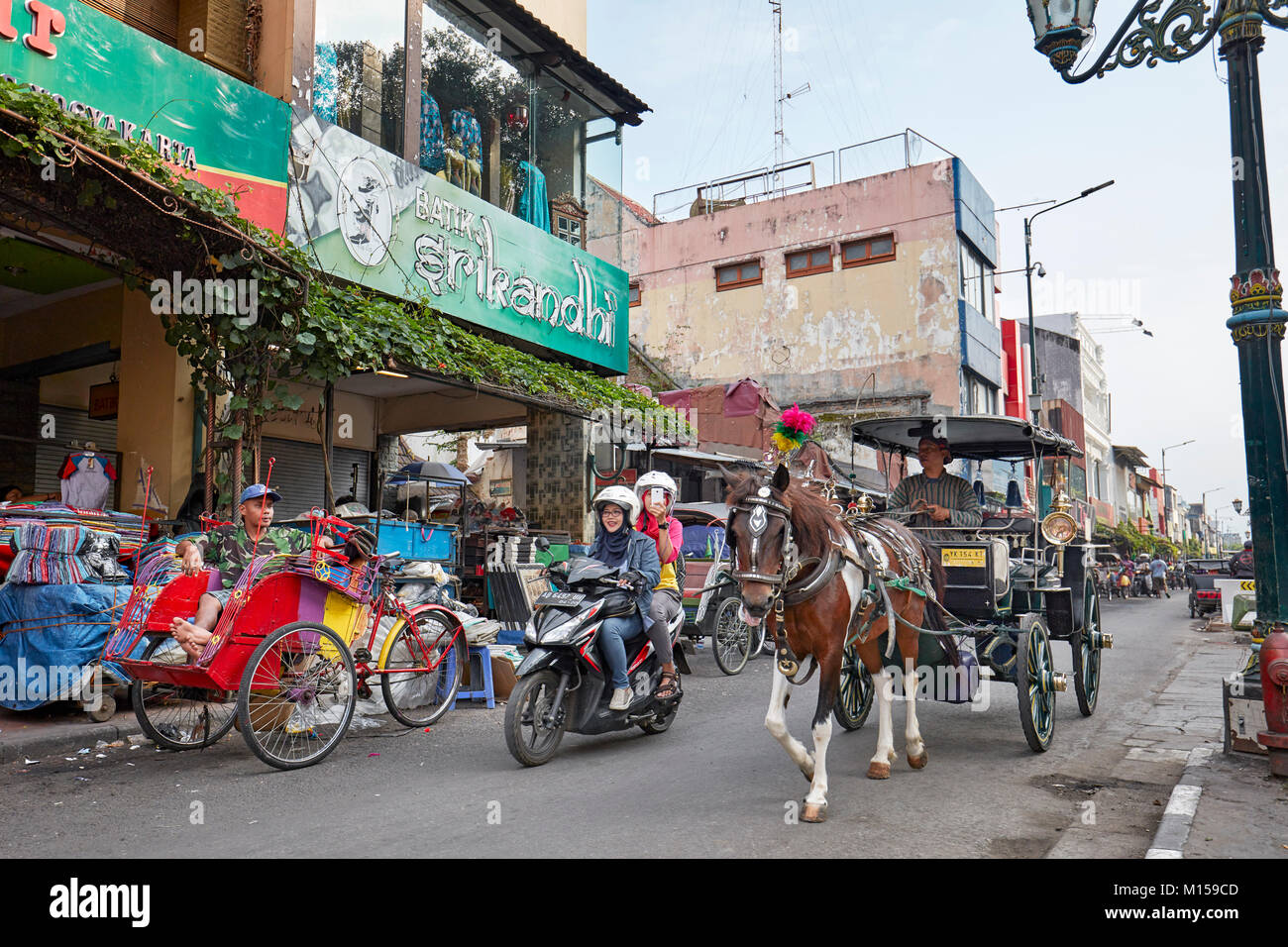 Horse-drawn carriage moving along Malioboro Street. Yogyakarta, Java ...