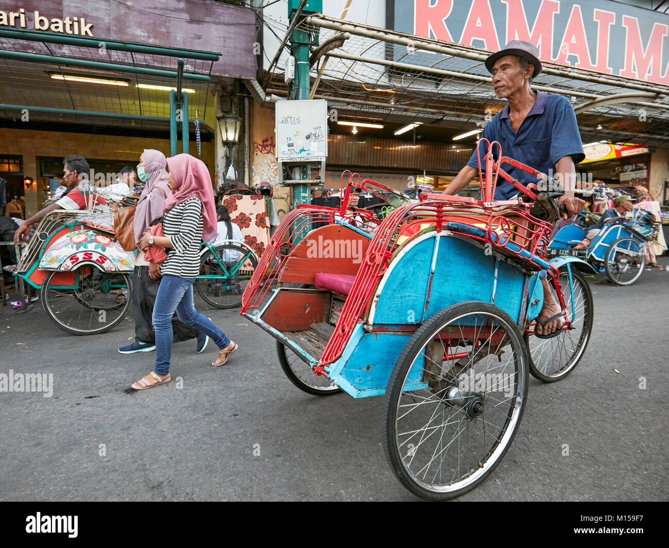Cycle rickshaw driving along Malioboro Street. Yogyakarta, Java ...