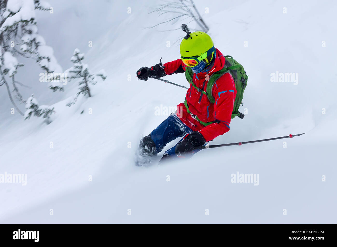 Skier freerider rides from powder snow on background of forest and ...