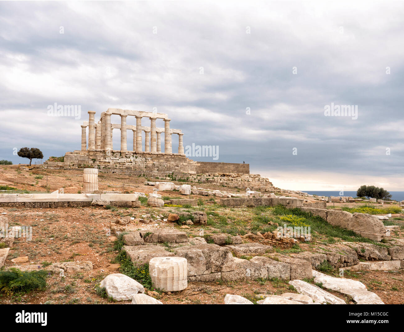 Ruins of an ancient Greek temple of Poseidon under dramatic cloudy sky ...