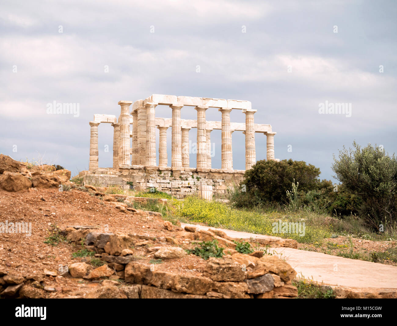 Ruins of an ancient Greek temple of Poseidon under dramatic cloudy sky ...