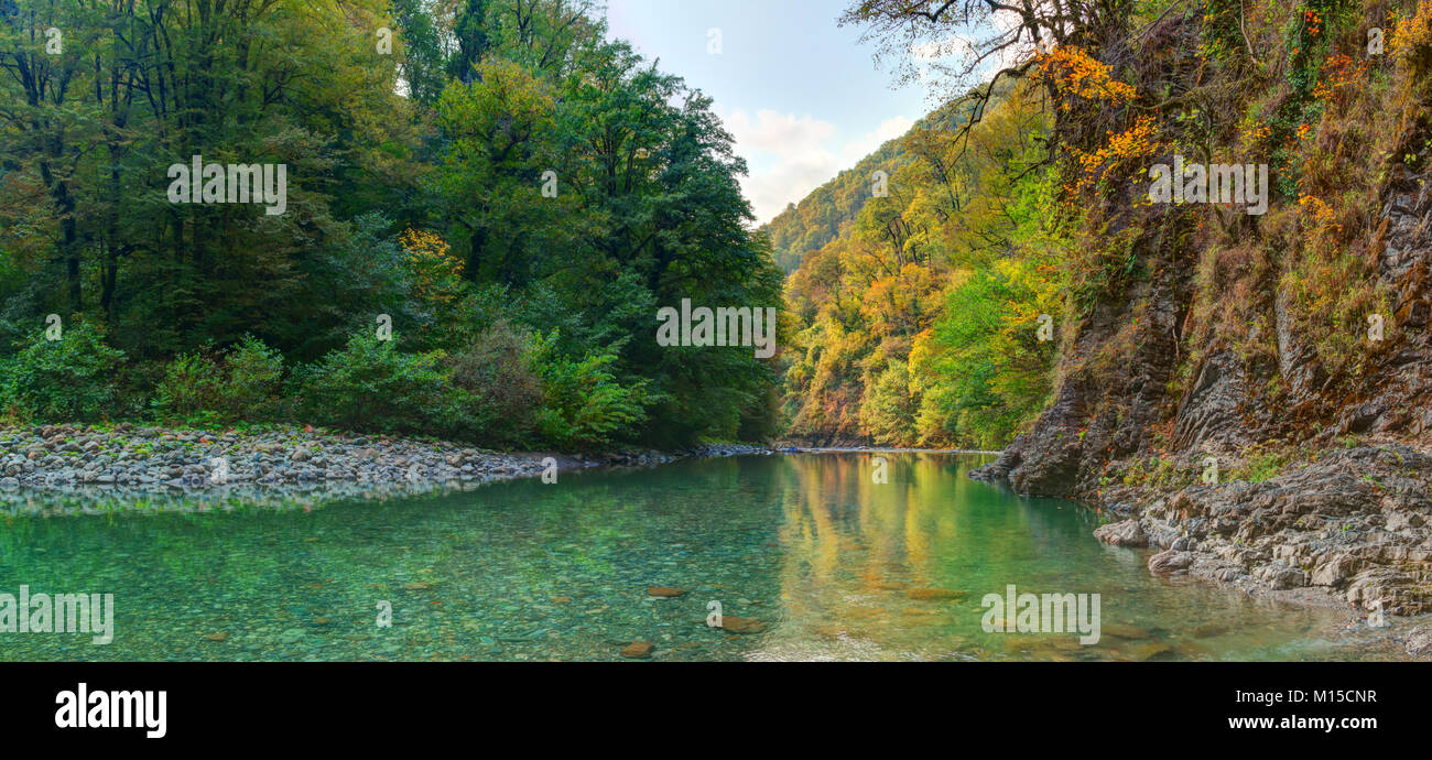 The valley of Sochi River with rocky walls and thicket with varicolored ...