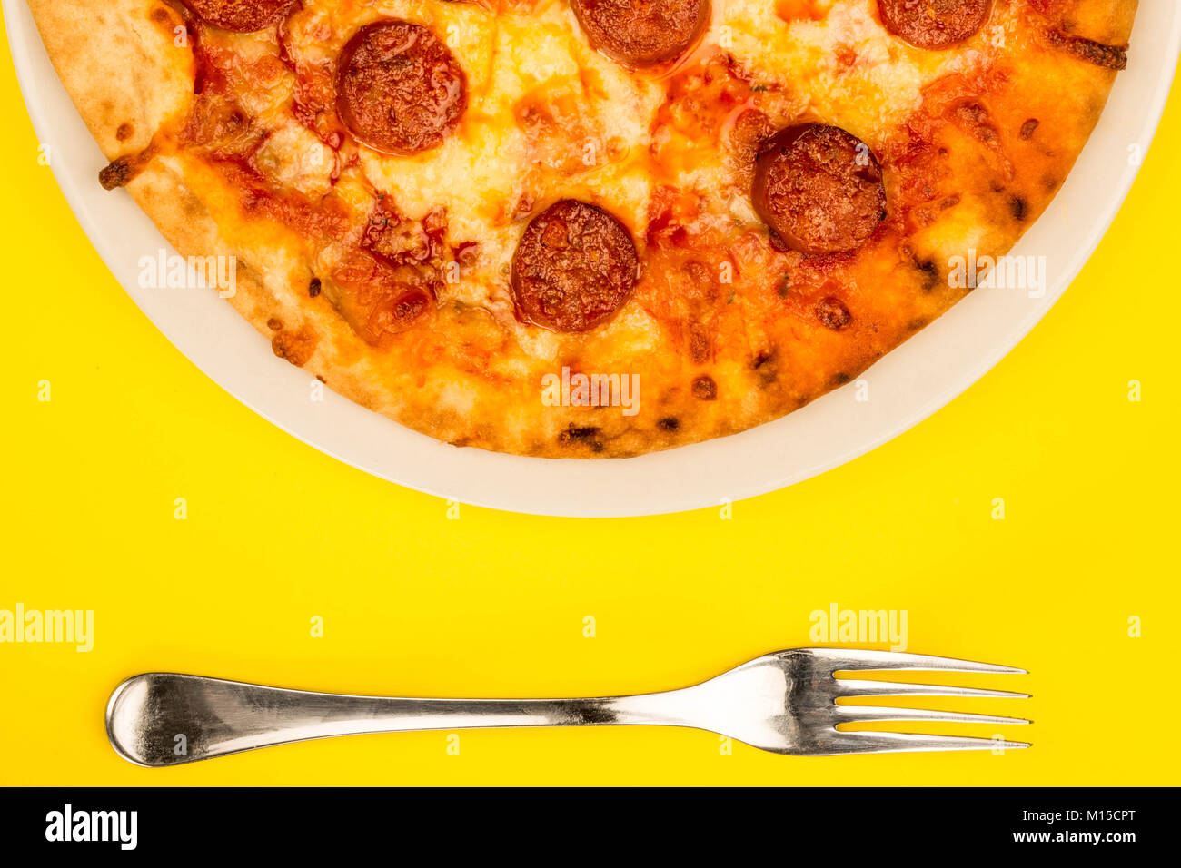 Italian Style Pepperoni Pizza Against A Yellow Background Stock Photo ...