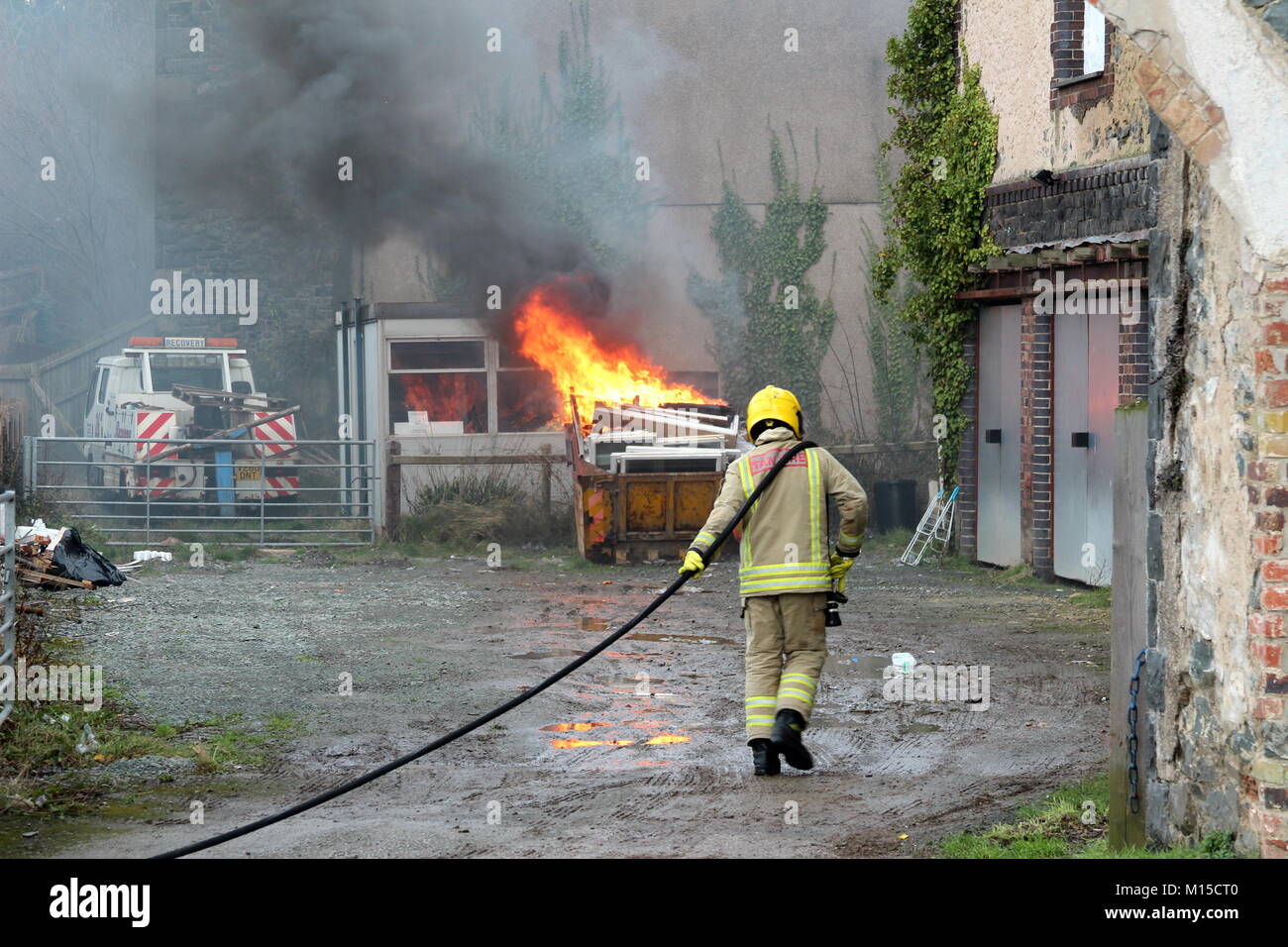 Fire Brigade attending a skip fire in North Wales Stock Photo - Alamy