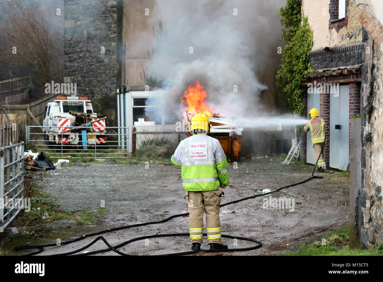 Fire Brigade attending a skip fire in North Wales Stock Photo - Alamy