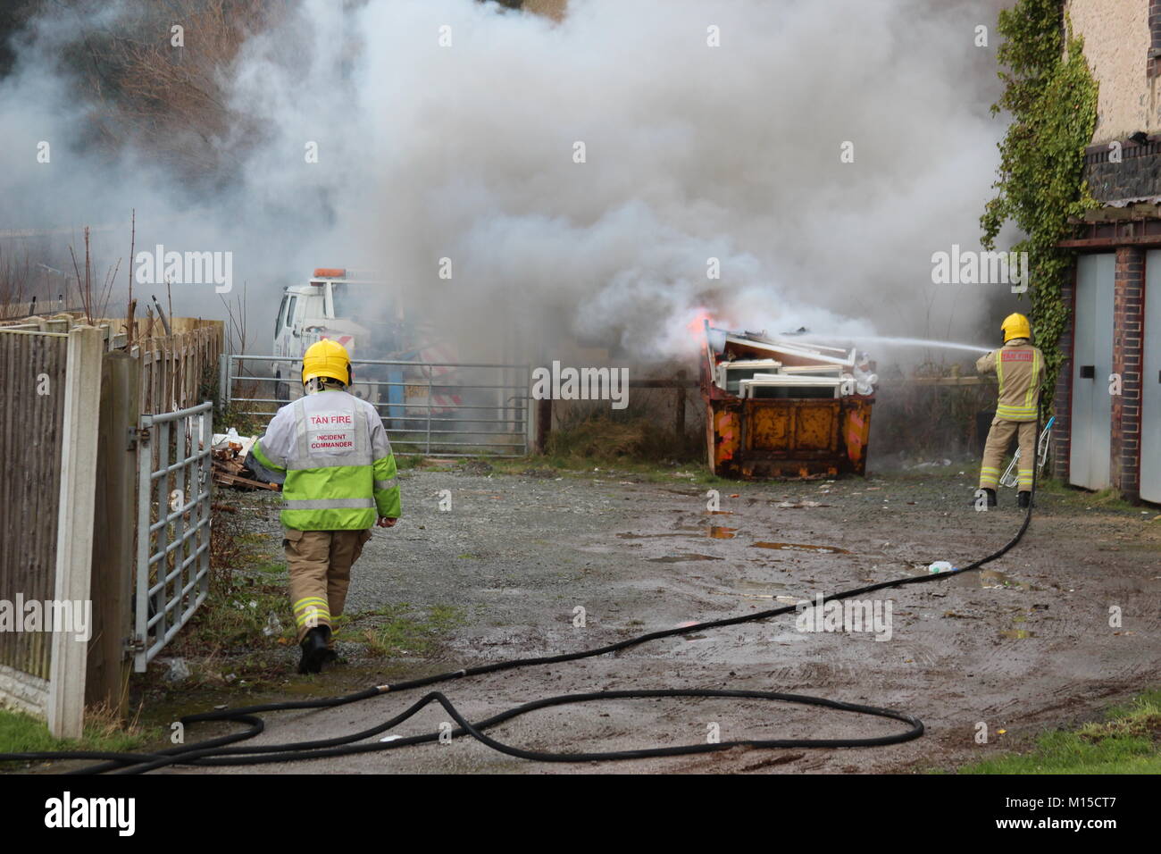 Fire Brigade attending a skip fire in North Wales Stock Photo - Alamy