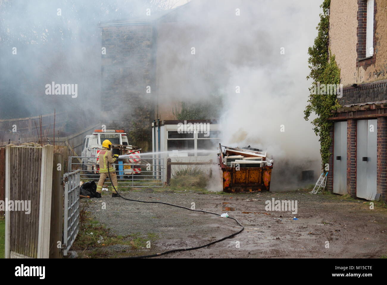 Fire Brigade attending a skip fire in North Wales Stock Photo - Alamy