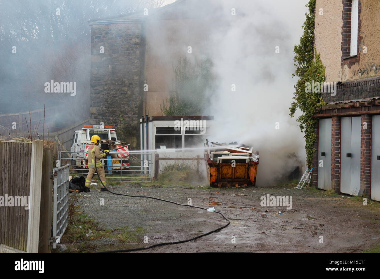 Fire Brigade attending a skip fire in North Wales Stock Photo - Alamy