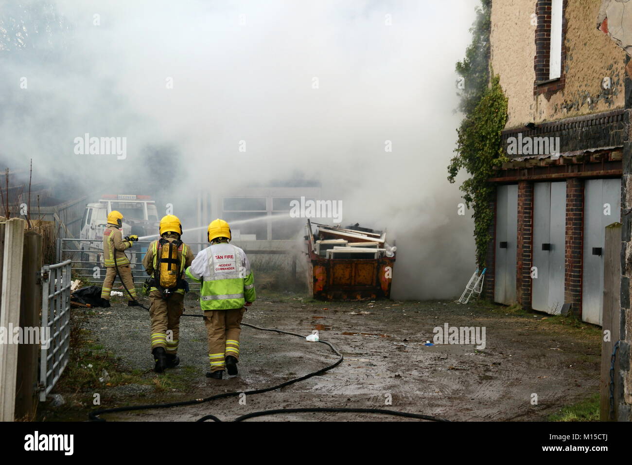 Fire Brigade attending a skip fire in North Wales Stock Photo - Alamy