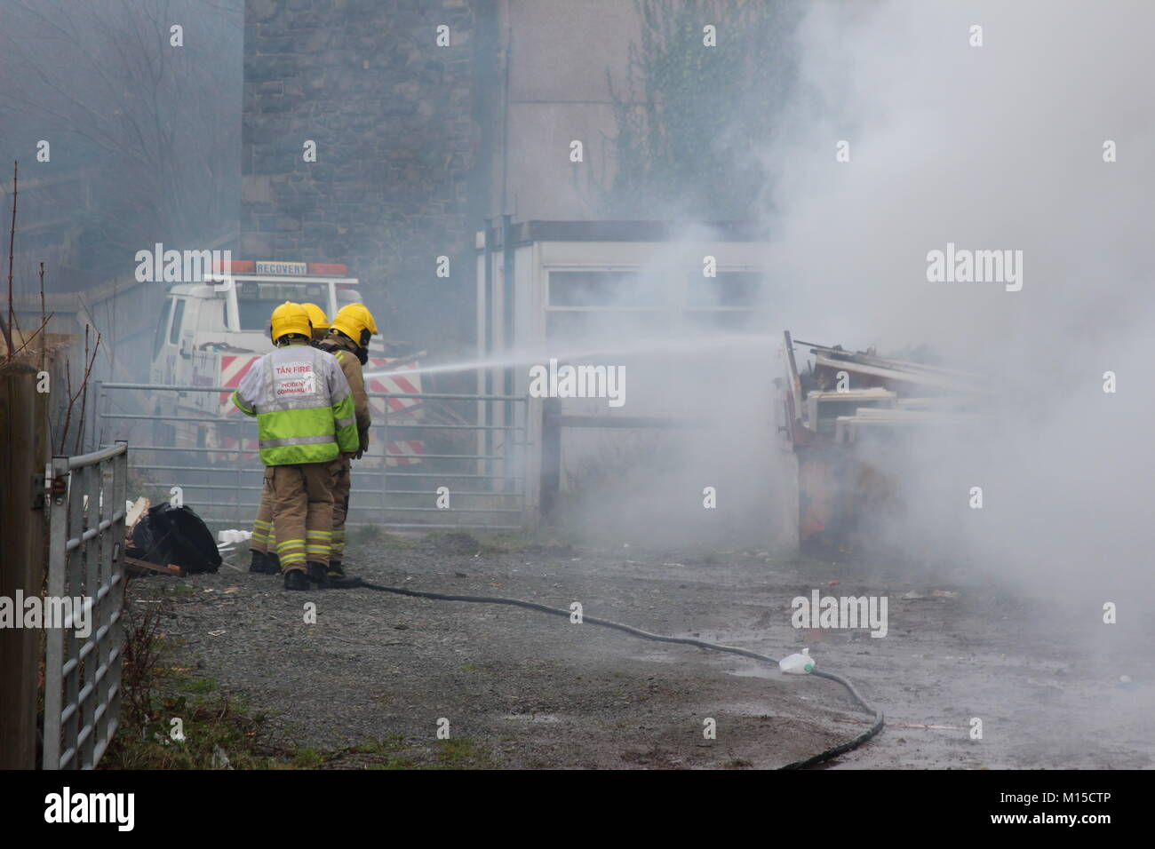 Fire Brigade attending a skip fire in North Wales Stock Photo - Alamy