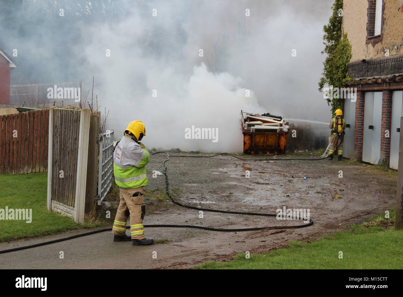 Fire Brigade attending a skip fire in North Wales Stock Photo - Alamy