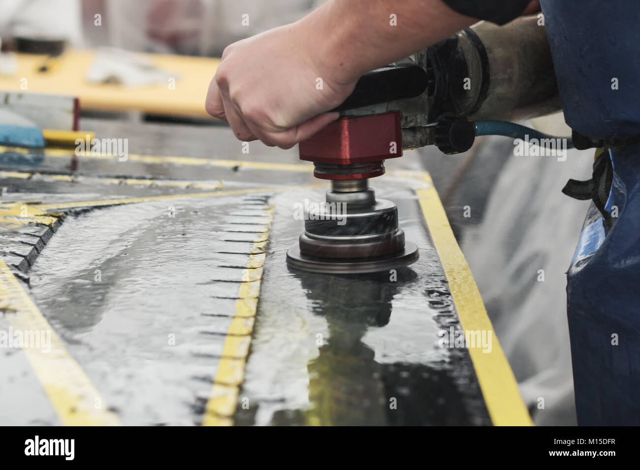hand grinding the plate with wet grinder tool Stock Photo - Alamy