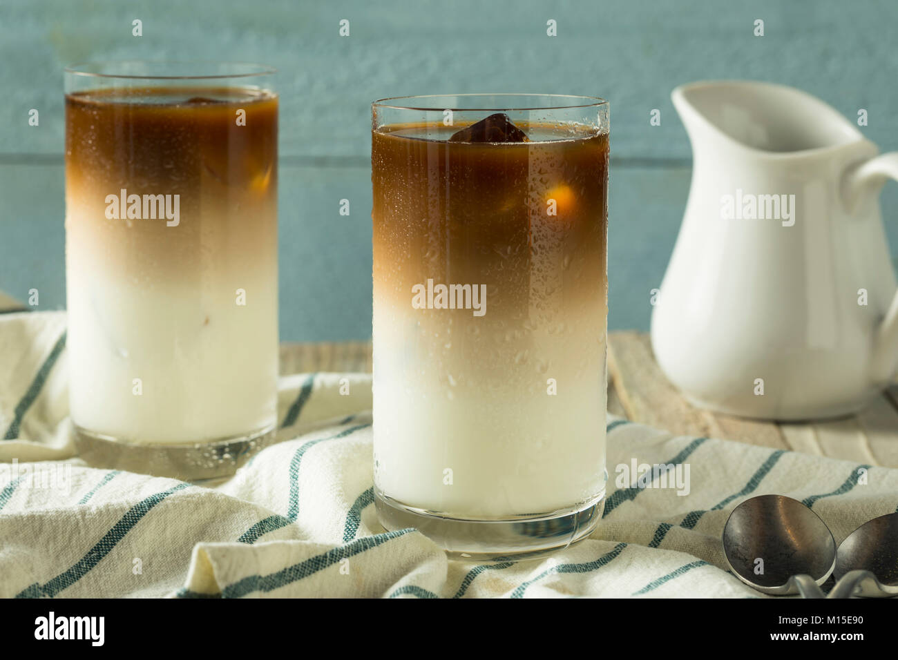 Refreshing Homemade Layered Iced Coffee with Milk Stock Photo - Alamy