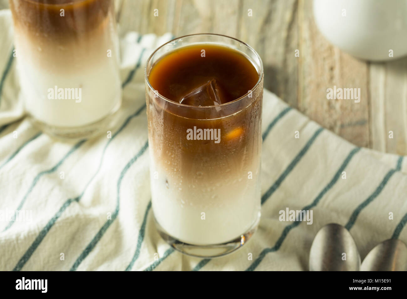 Refreshing Homemade Layered Iced Coffee with Milk Stock Photo - Alamy