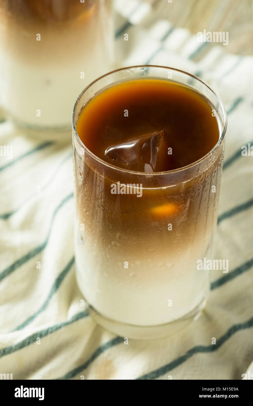 Refreshing Homemade Layered Iced Coffee with Milk Stock Photo - Alamy