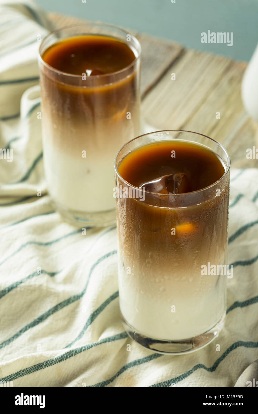 Refreshing Homemade Layered Iced Coffee with Milk Stock Photo - Alamy