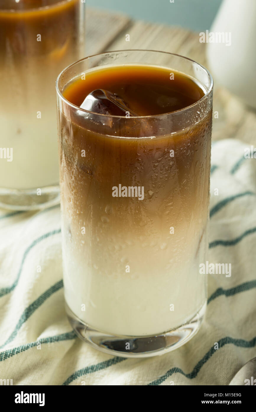 Refreshing Homemade Layered Iced Coffee with Milk Stock Photo - Alamy