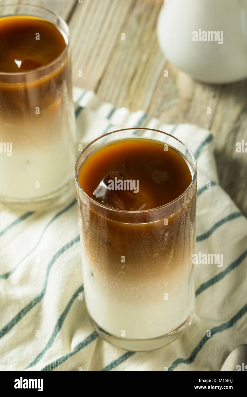 Refreshing Homemade Layered Iced Coffee with Milk Stock Photo - Alamy